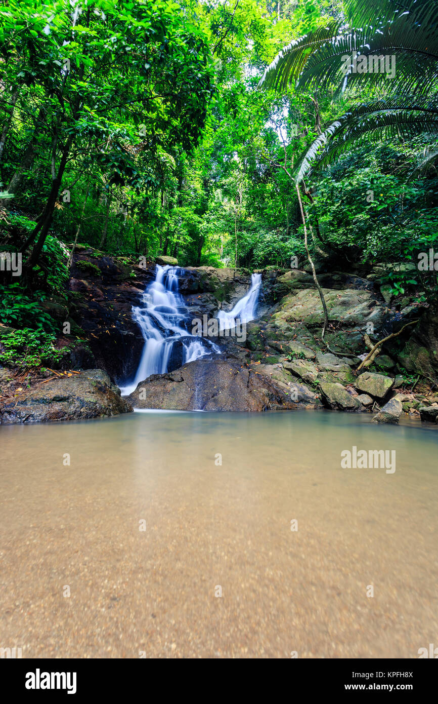 Kathu waterfall in a tropical forest at sunny day. Phuket, Thailand ...
