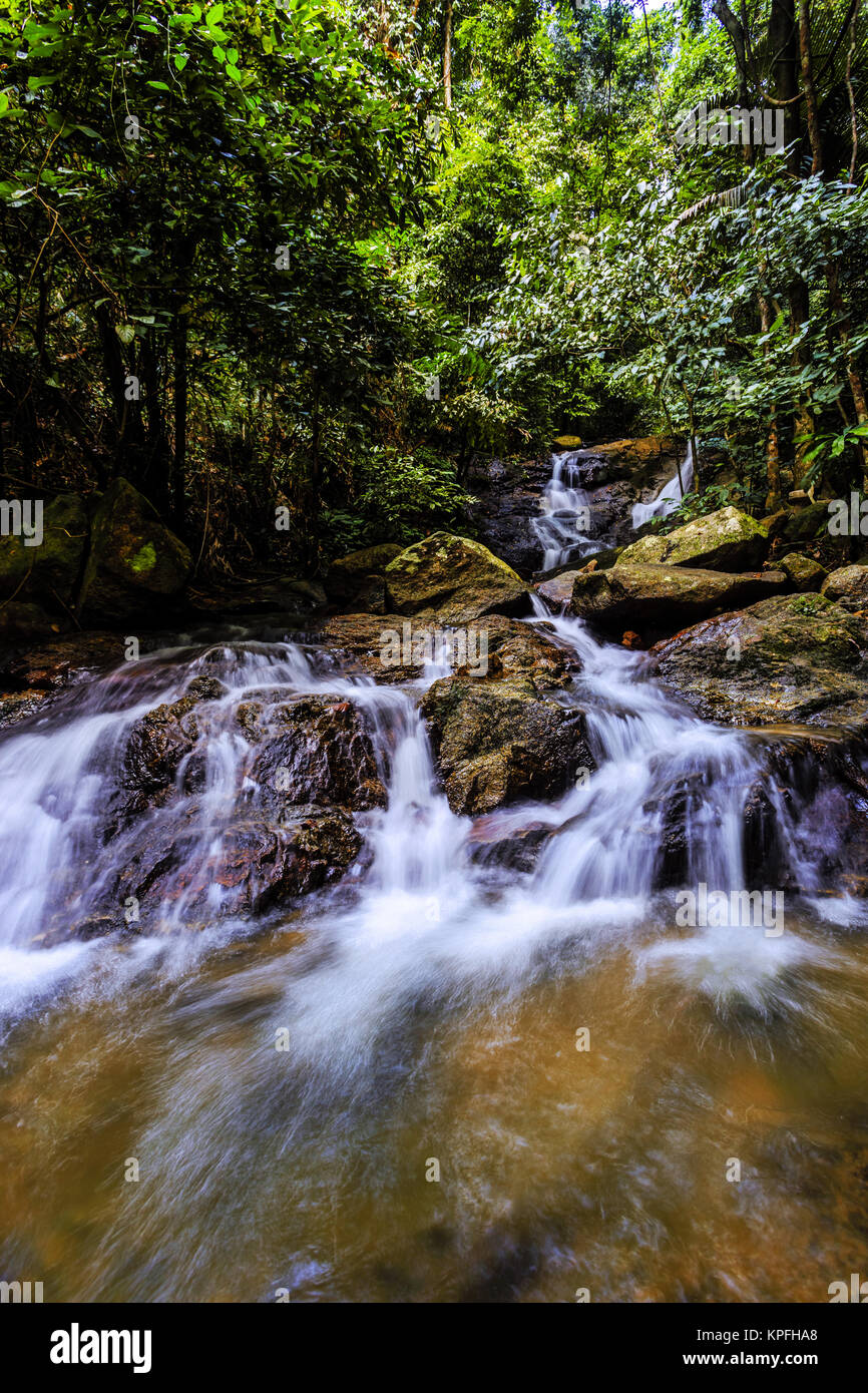 Kathu waterfall in a tropical forest at sunny day. Phuket, Thailand ...