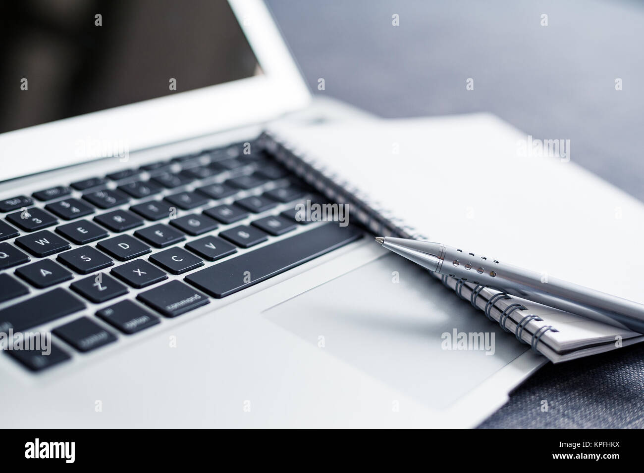 Laptop and note book Stock Photo - Alamy