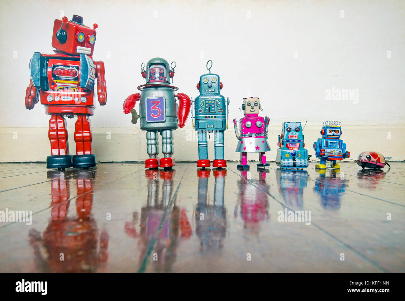 a line of retro robots on a wooden floor with reflection Stock Photo ...