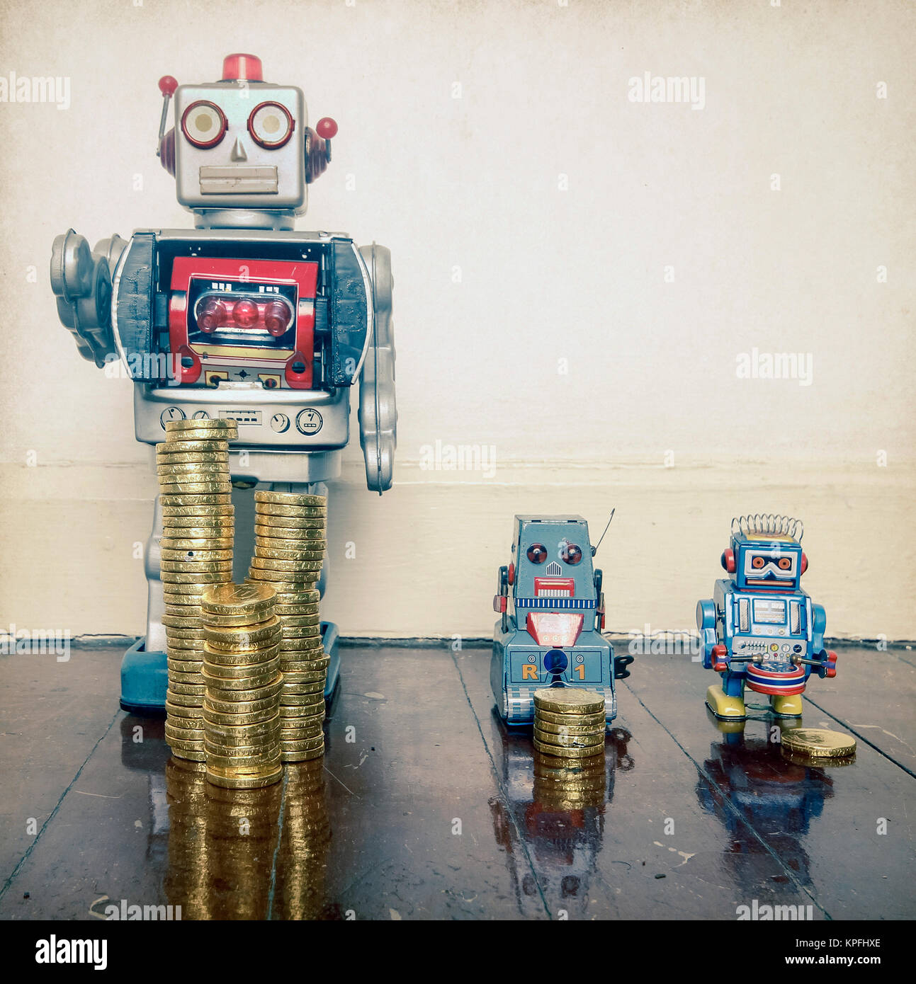 two vintage robots with gold money on a wooden floor with reflection ...