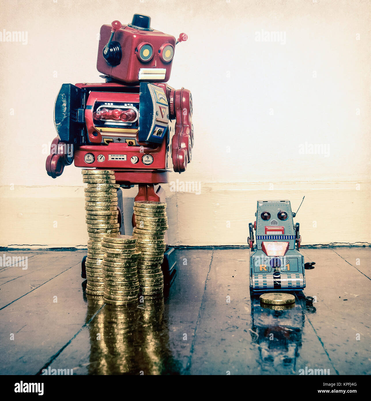 two vintage robots with gold money on a wooden floor with reflection ...