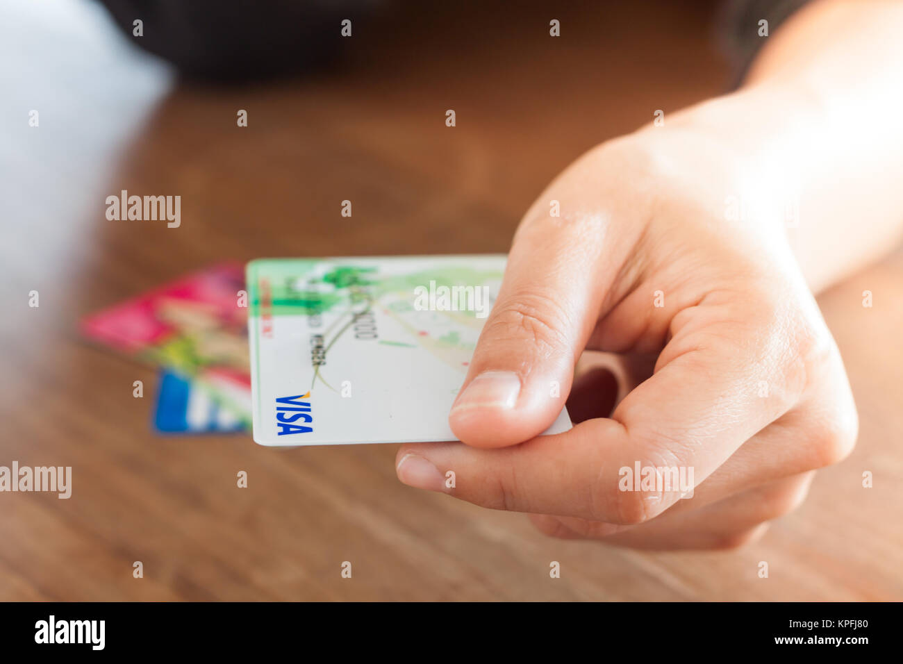 Visa cards on wooden table Stock Photo - Alamy