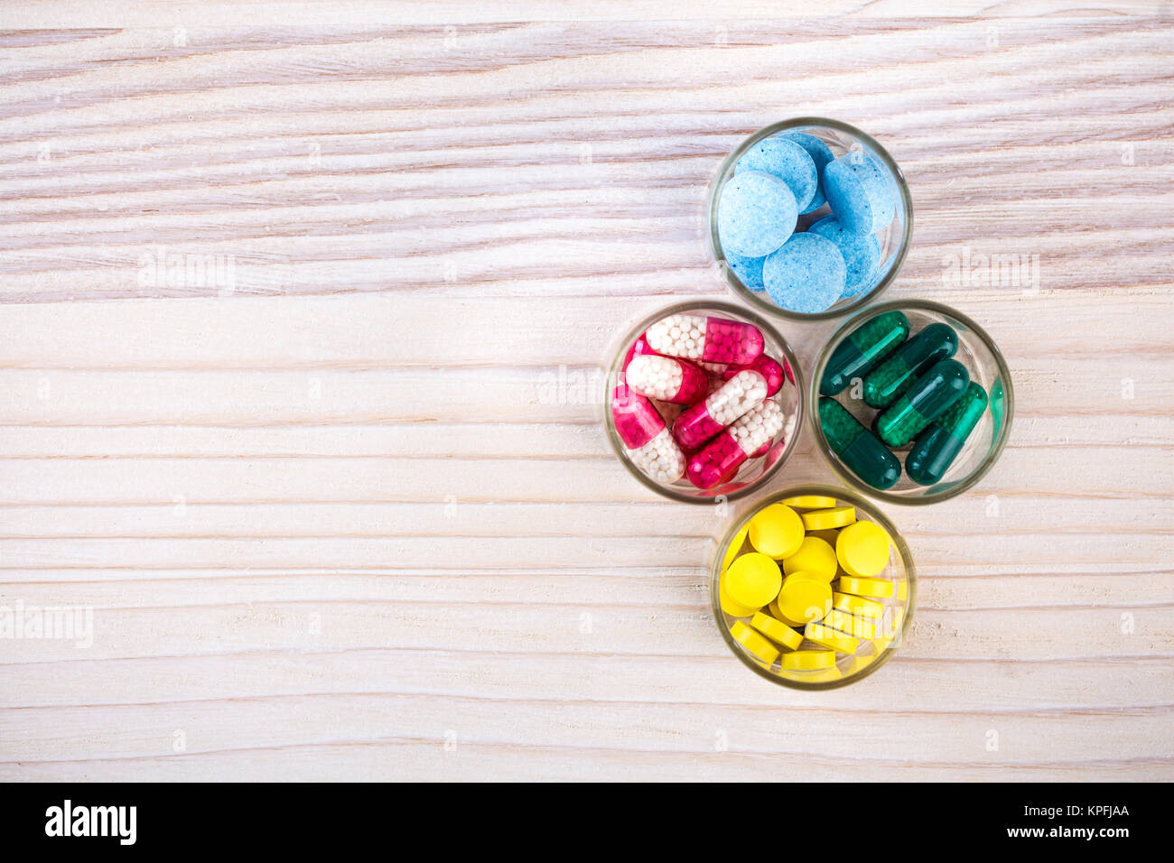 Pills and capsules in glass containers Stock Photo - Alamy