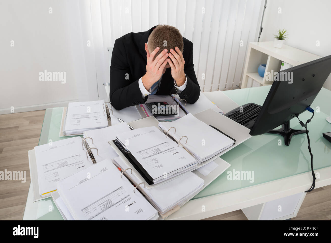 Stressed Businessman Sitting At Office Desk Stock Photo - Alamy