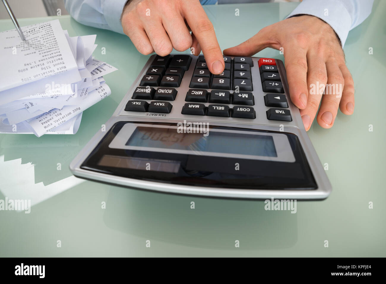 Businessperson Using Calculator Stock Photo - Alamy