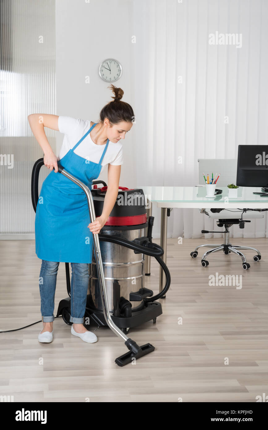 Female Janitor Cleaning Floor With Vacuum Cleaner Stock Photo - Alamy