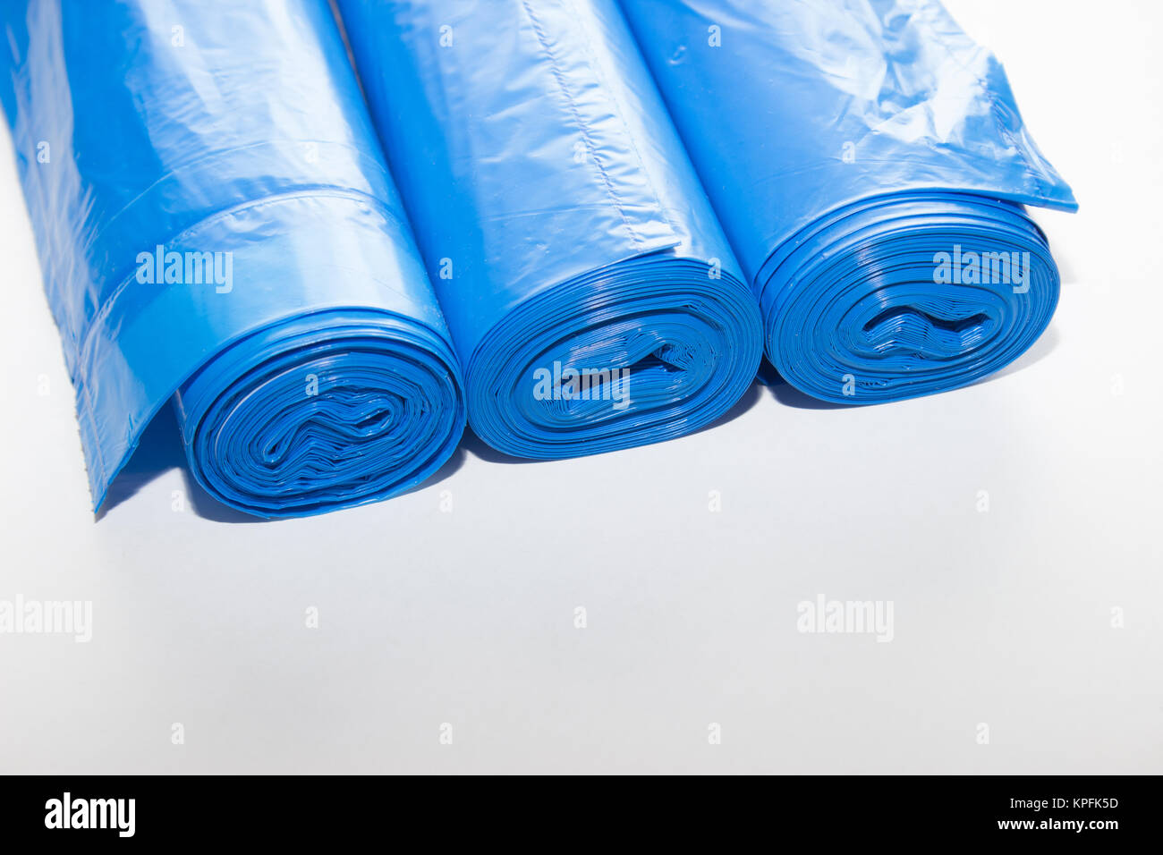 Roll of blue plastic garbage bags isolated on white Stock Photo - Alamy