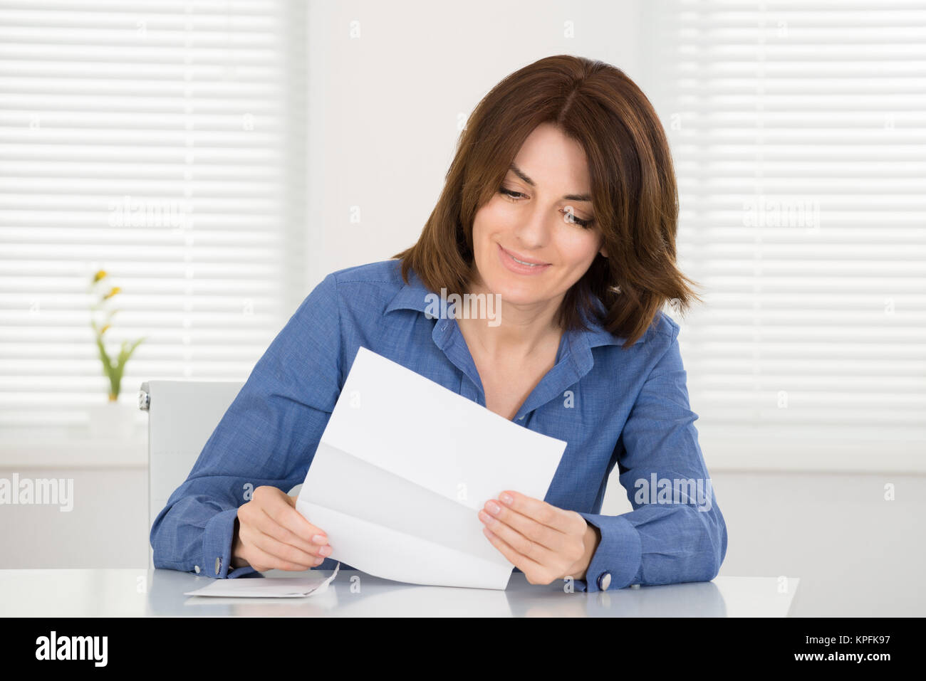 Happy Woman Reading Letter Stock Photo - Alamy