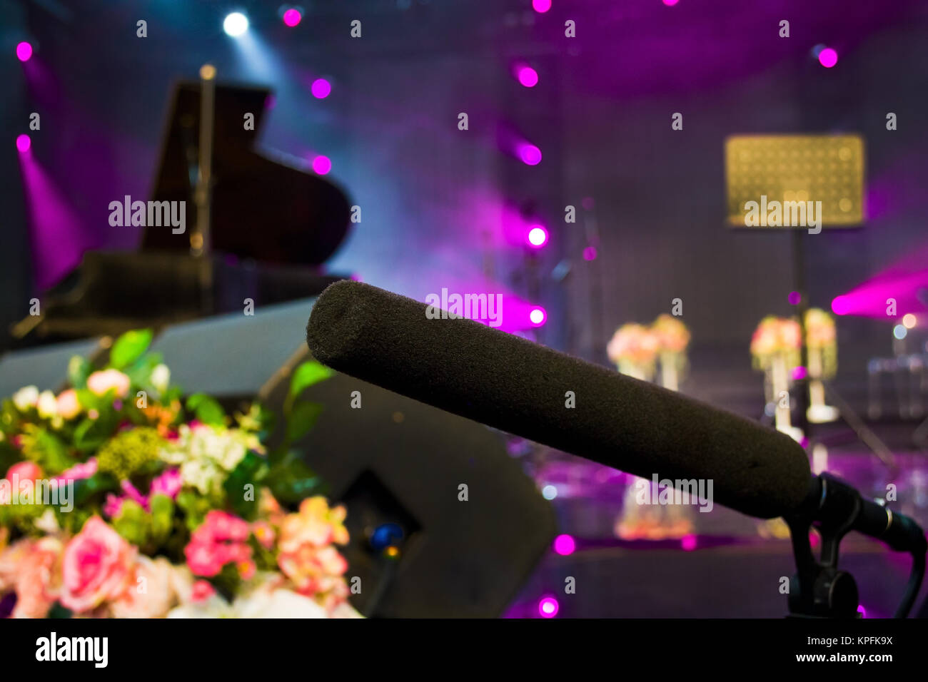 close up on a microphone during recording session with a singer piano ...