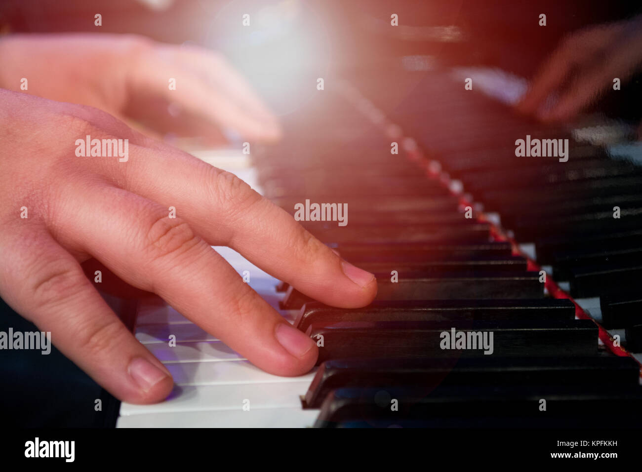 playing piano with light sunset background Stock Photo - Alamy
