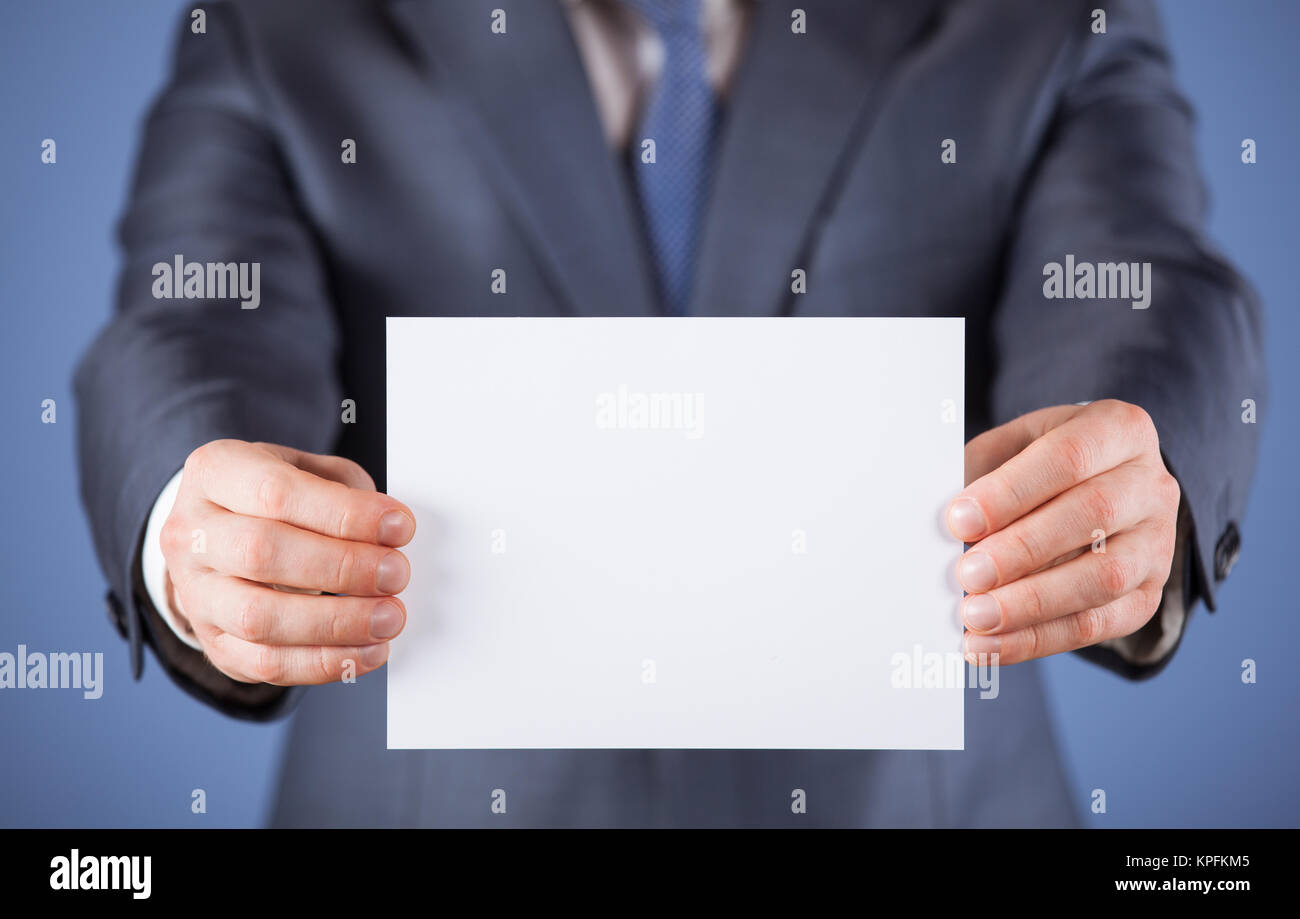 Businessman holding an empty sheet of paper Stock Photo - Alamy