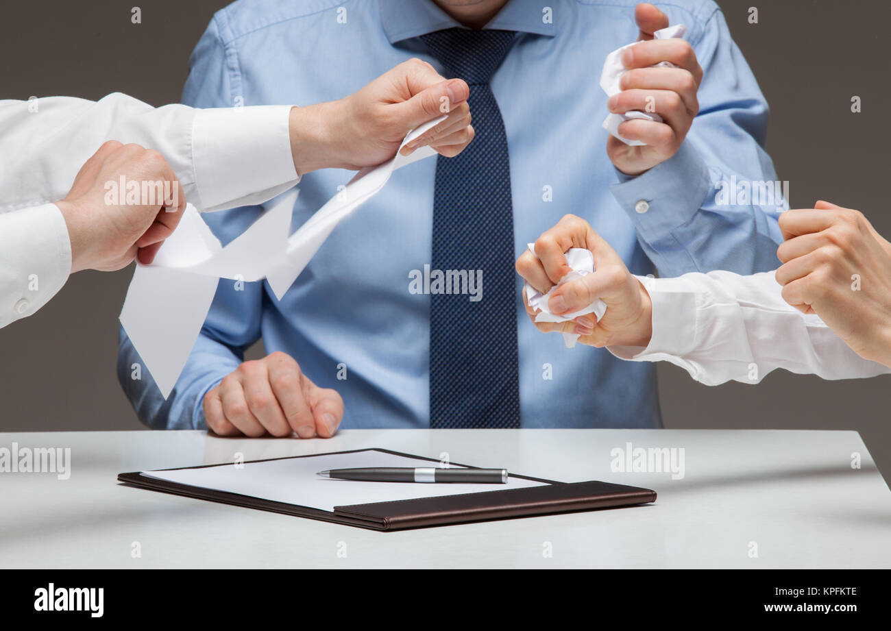 Business people cruelly tearing documents Stock Photo - Alamy