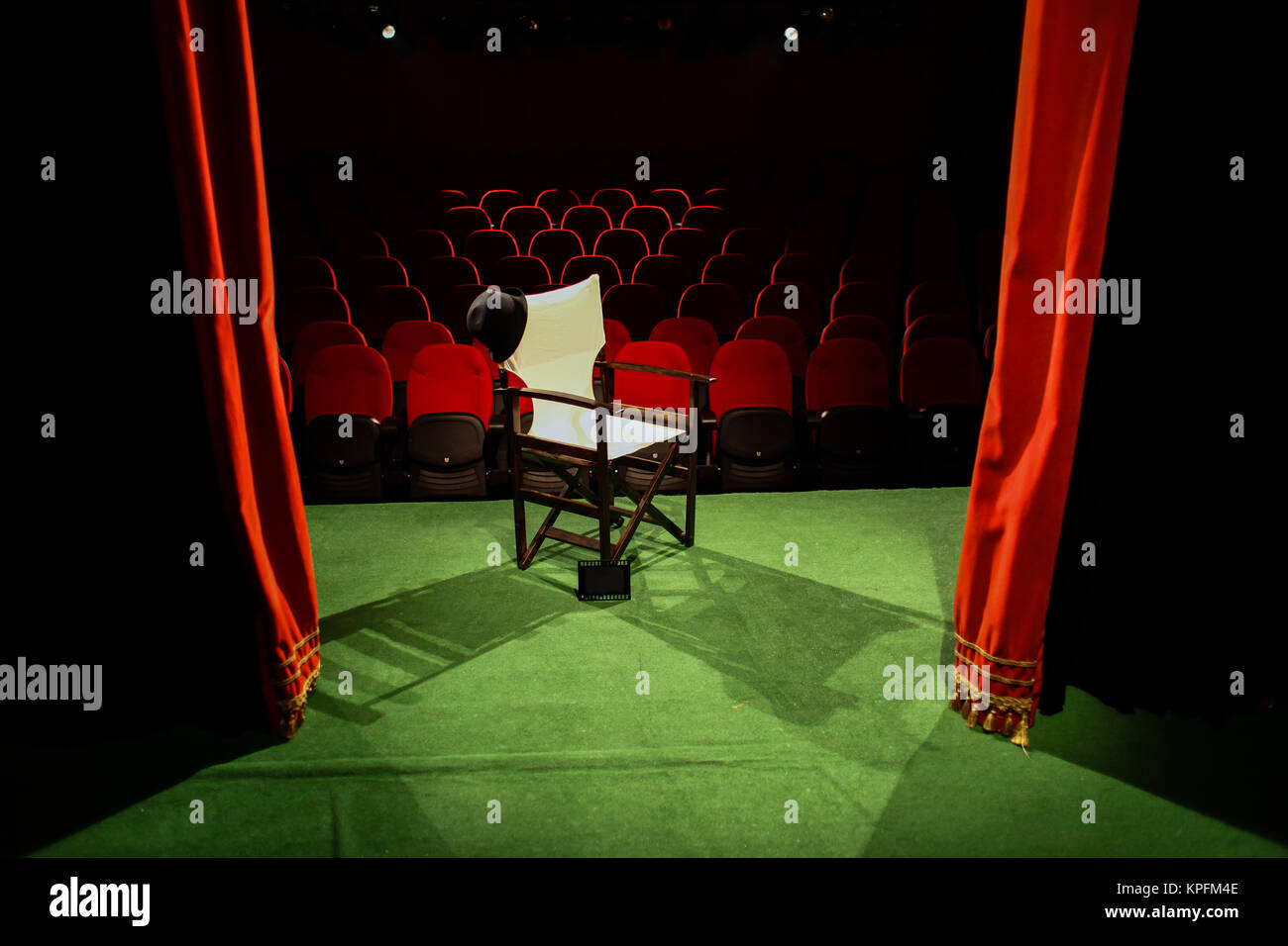 Director's chair on stage, in front of empty seats and in between ...