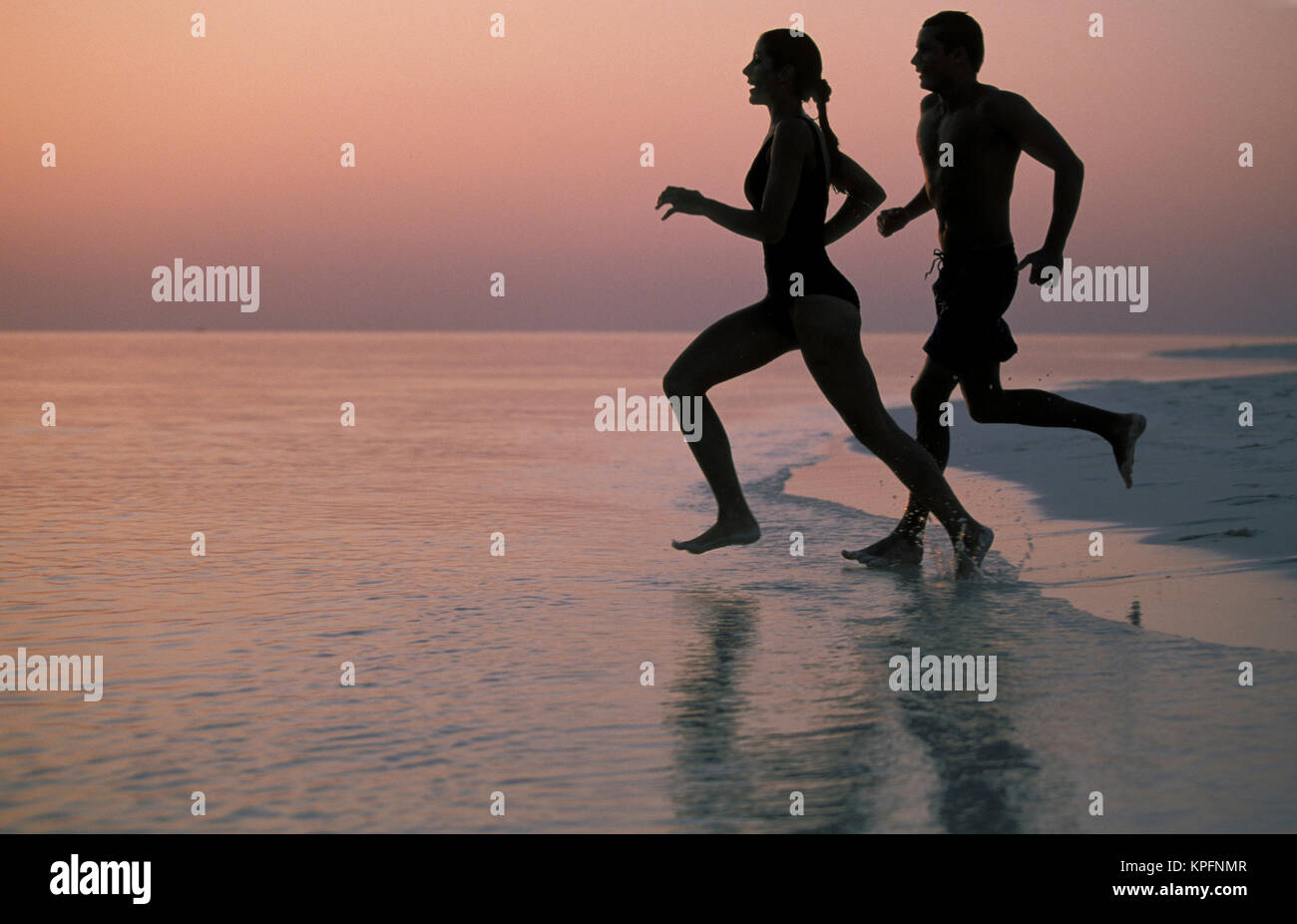 Asia, Maldives. Couple running on beach (MR Stock Photo - Alamy