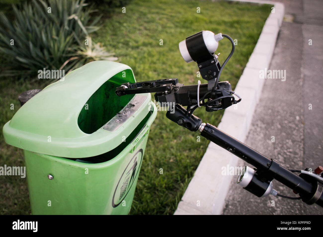 A remote controlled army robot is looking for threats in a garbage bin ...