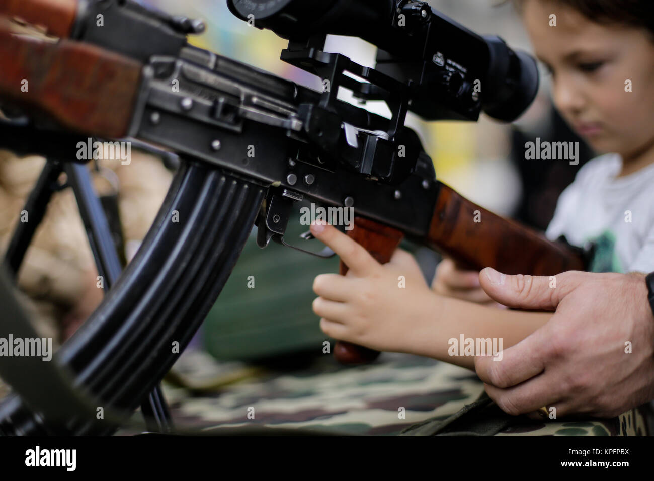 Little boy with assault rifle Stock Photo - Alamy
