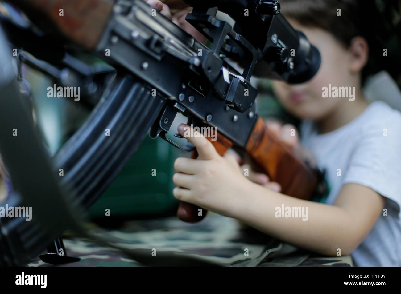 Little boy with assault rifle Stock Photo - Alamy