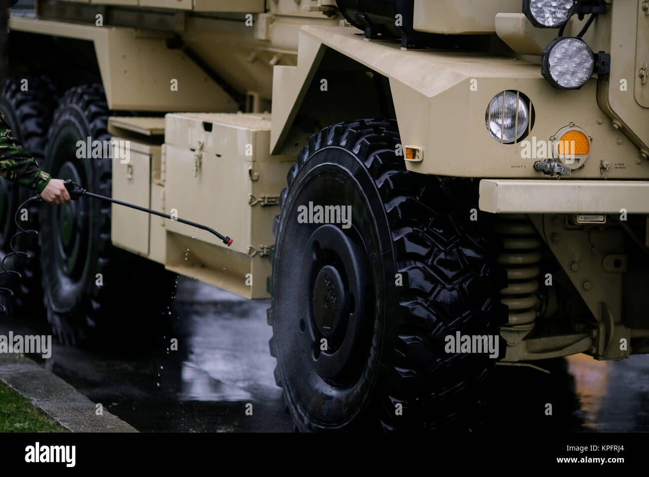 Soldier washing an armoured vehicle at a military parade Stock Photo ...