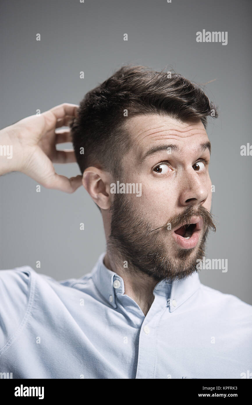 Portrait of young man with shocked facial expression Stock Photo - Alamy