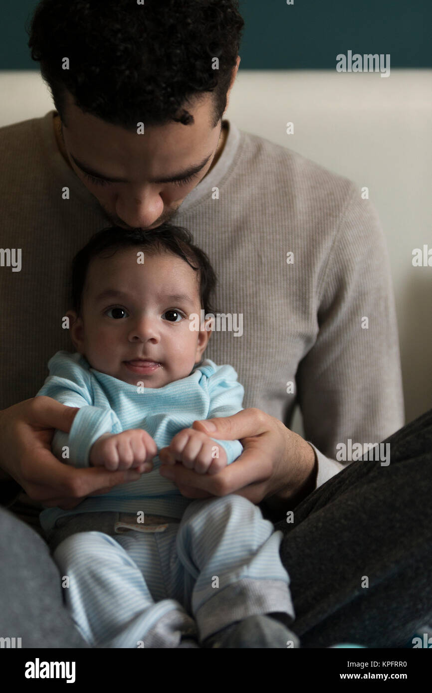 Cuddles with daddy Stock Photo - Alamy