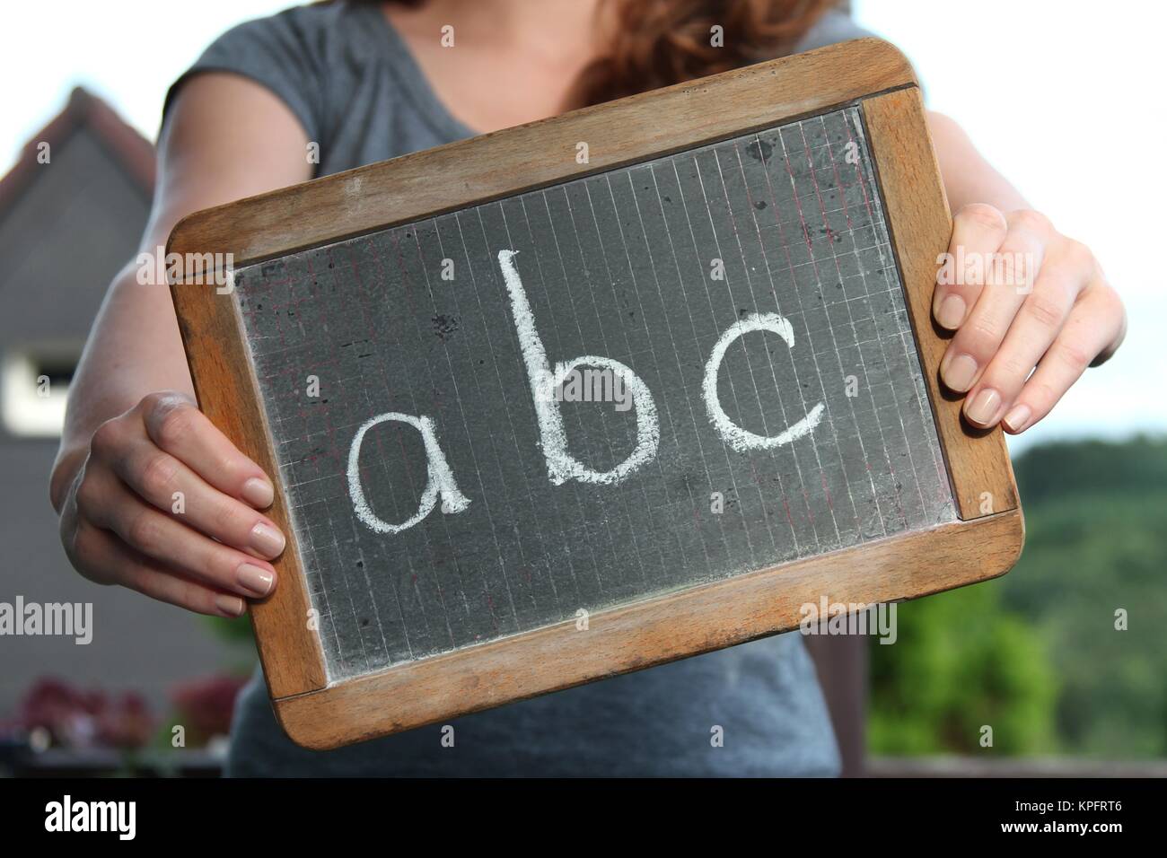abc written with chalk on slate shown by young female Stock Photo - Alamy