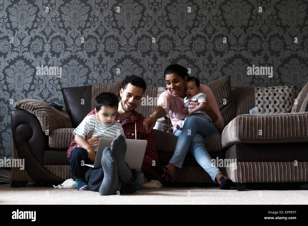 Family using laptop Stock Photo - Alamy
