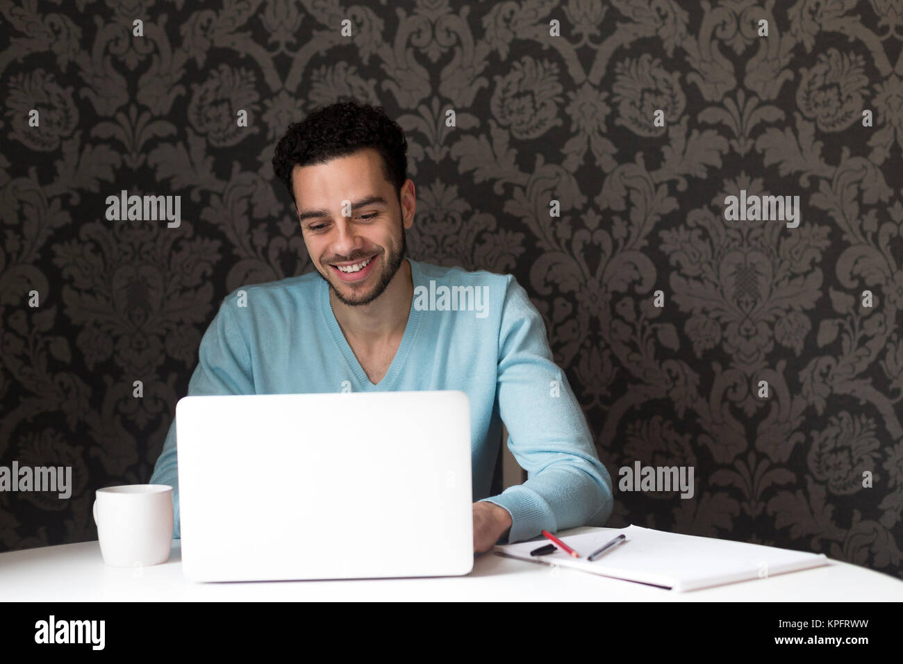Happy man using a laptop Stock Photo - Alamy