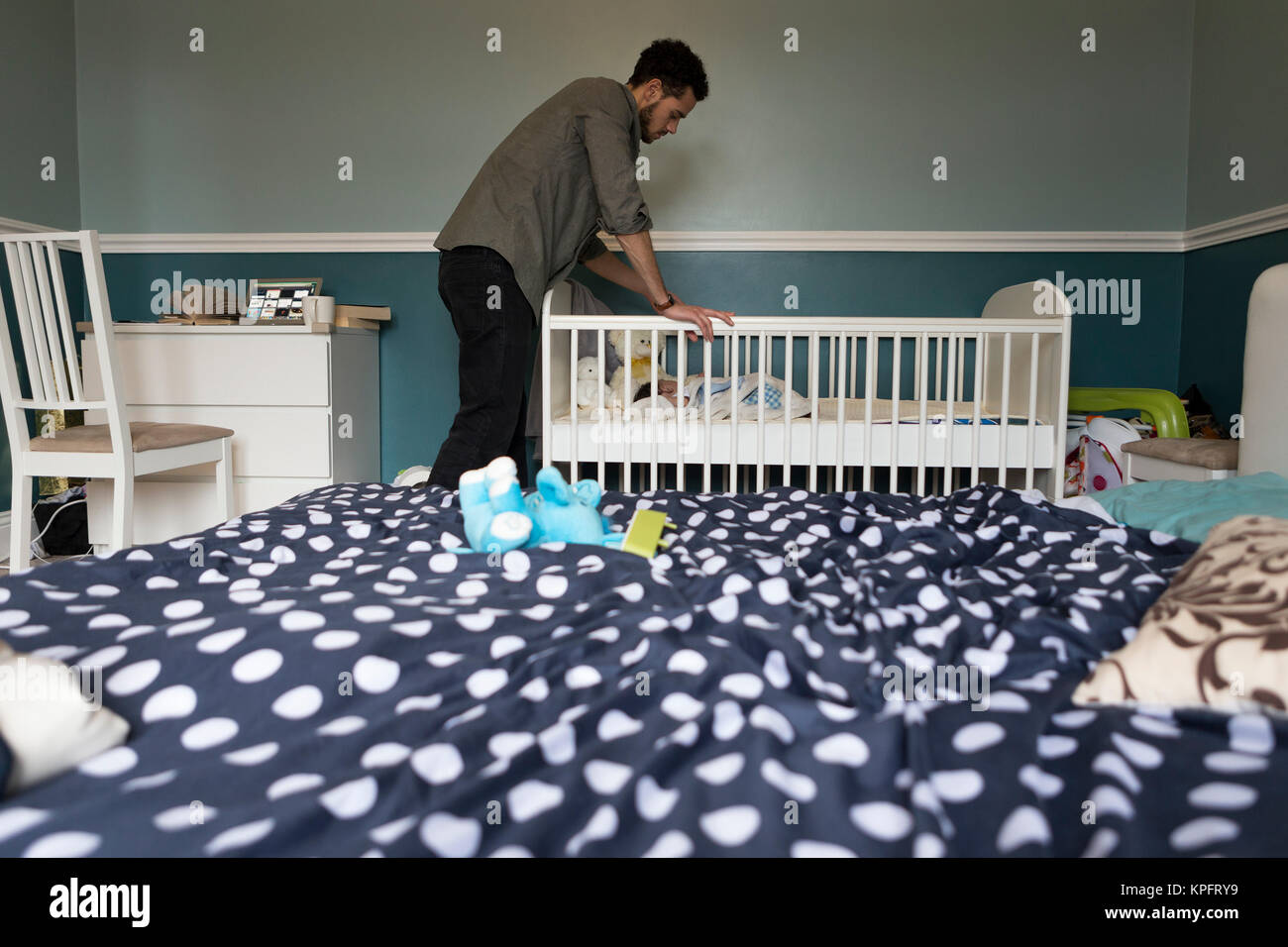 Checking on sleeping baby Stock Photo - Alamy