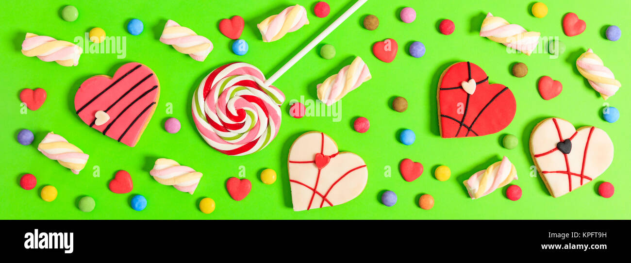 Colorful candies on bright green background, top view Stock Photo - Alamy