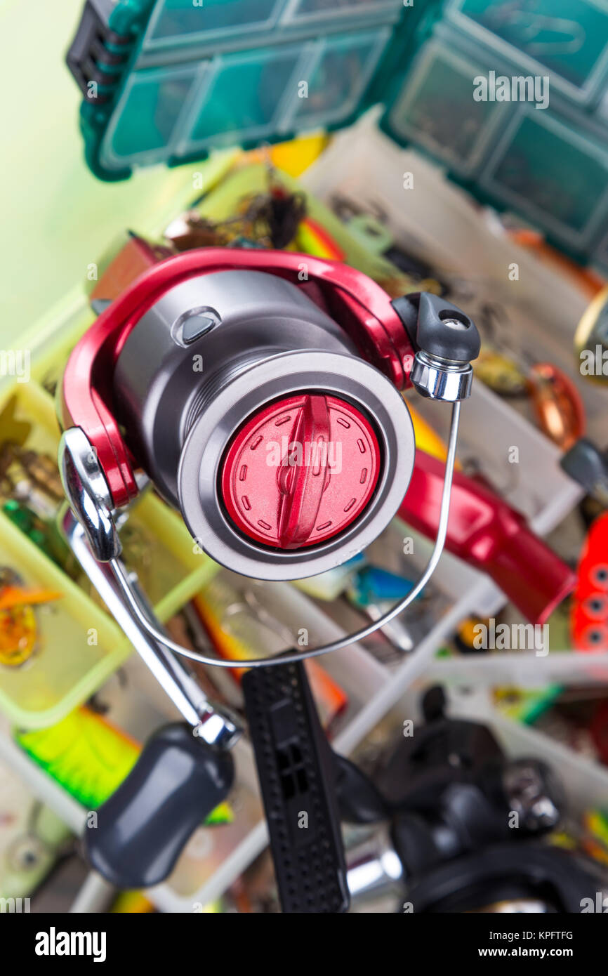 fishing reel on boxes with lures and wobblers Stock Photo - Alamy