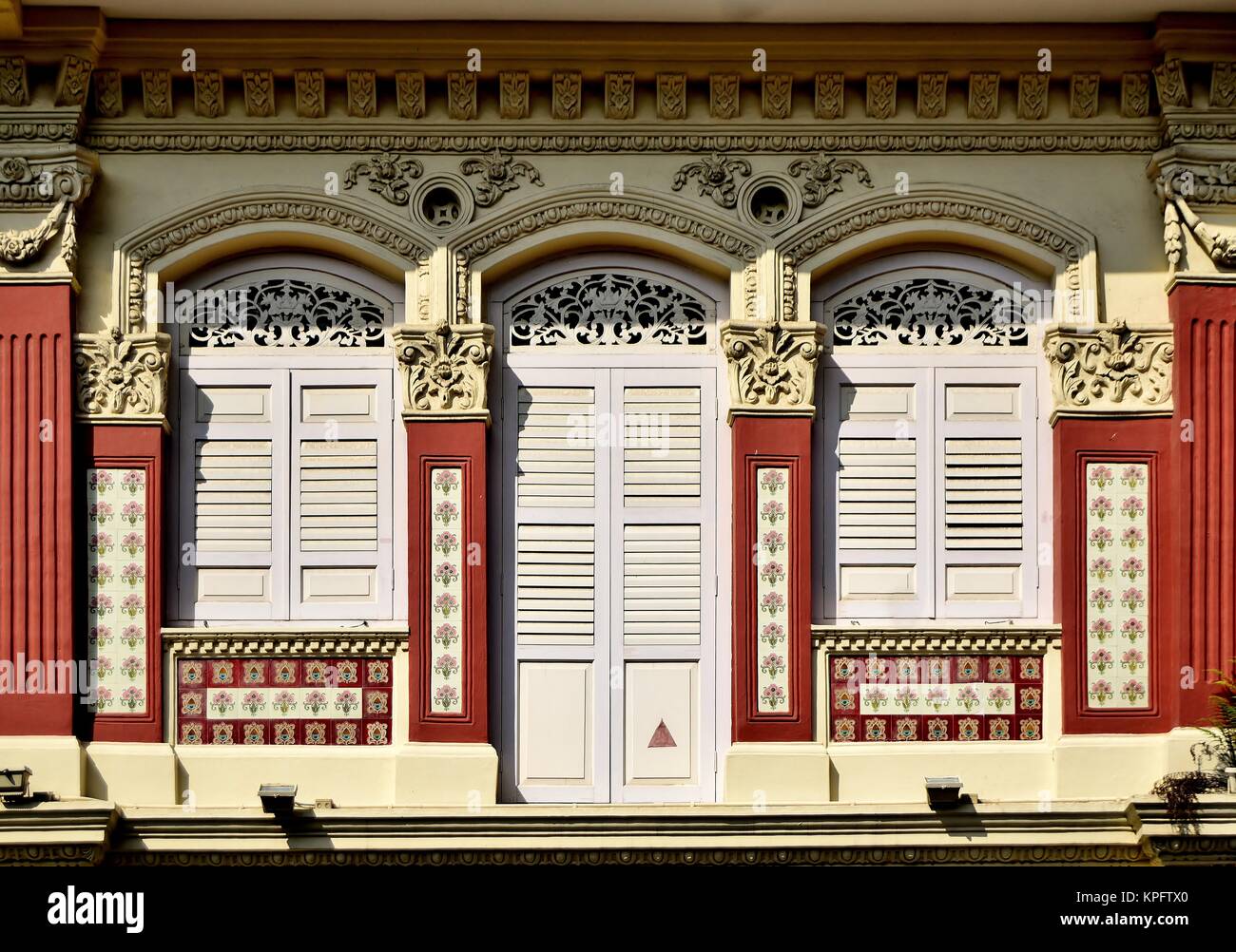 Classic Chinese Singapore shop house with arched windows, cream wooden ...
