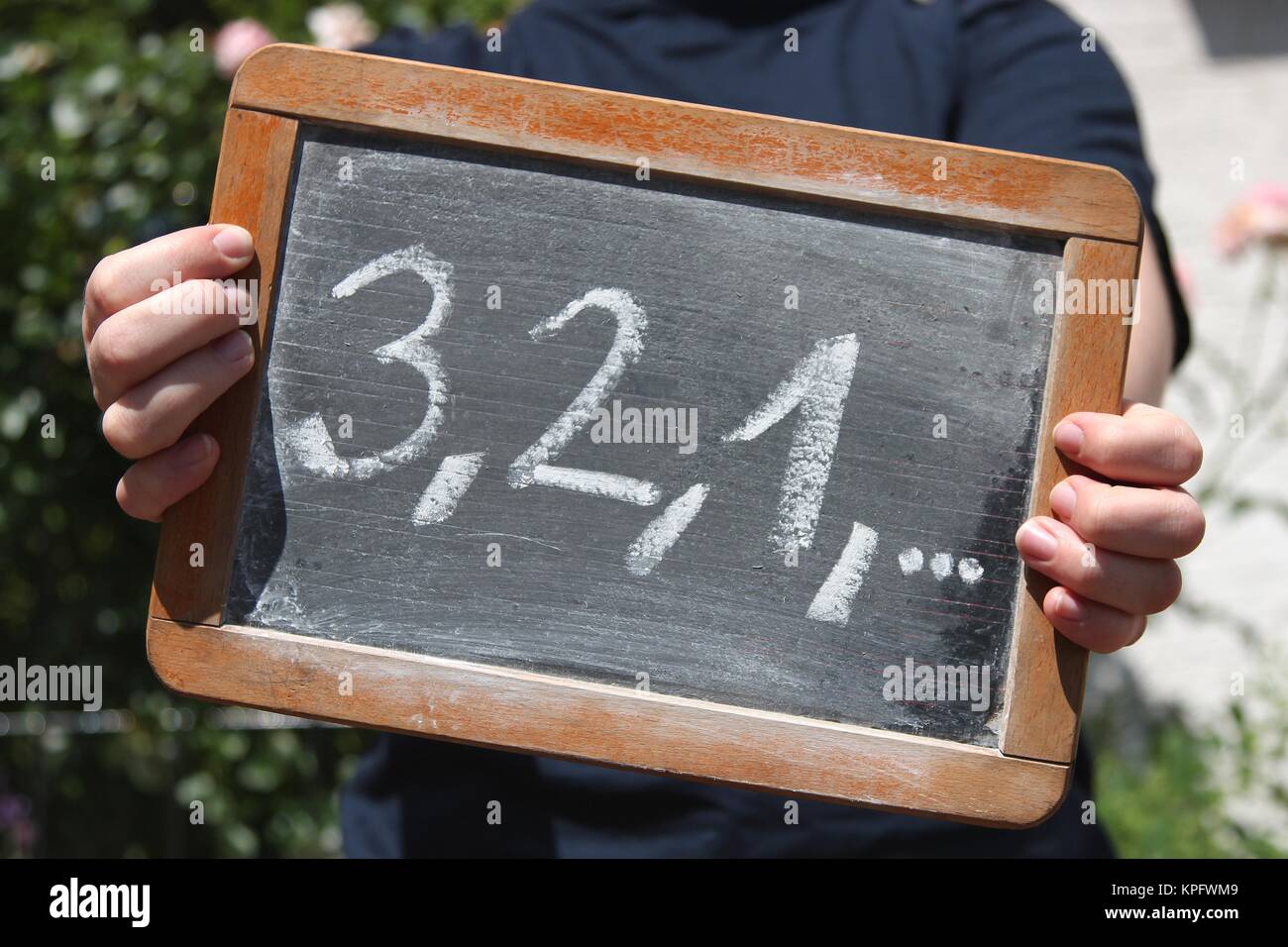 3,2,1 written with chalk on slate shown by young female Stock Photo - Alamy