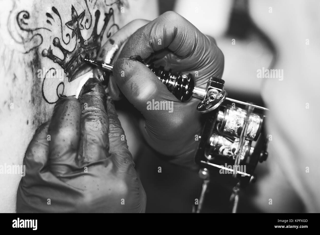 tattooer showing process of making a tattoo hands holding a tatoo ...