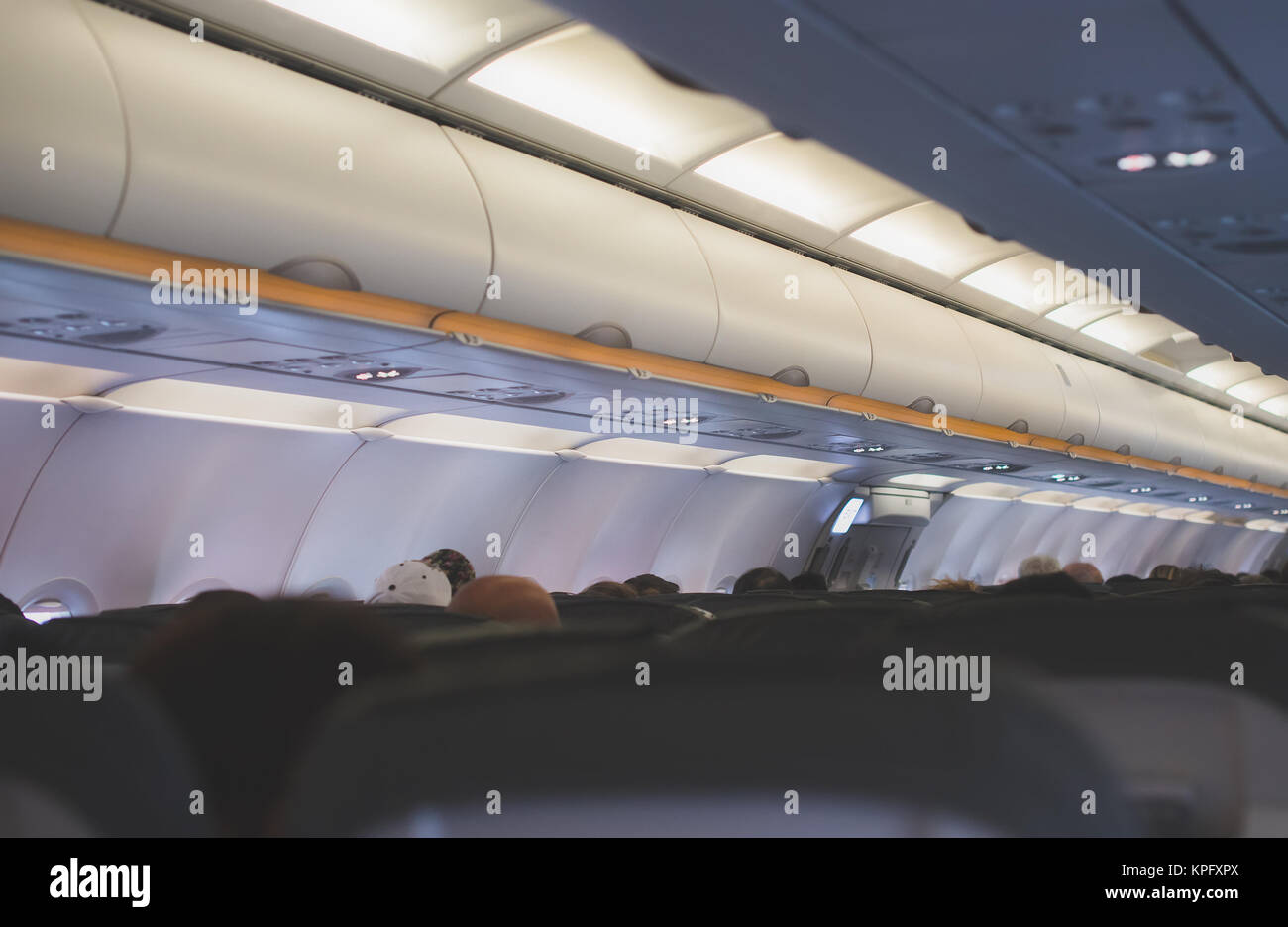 Interior inside of the plane with passengers Stock Photo - Alamy