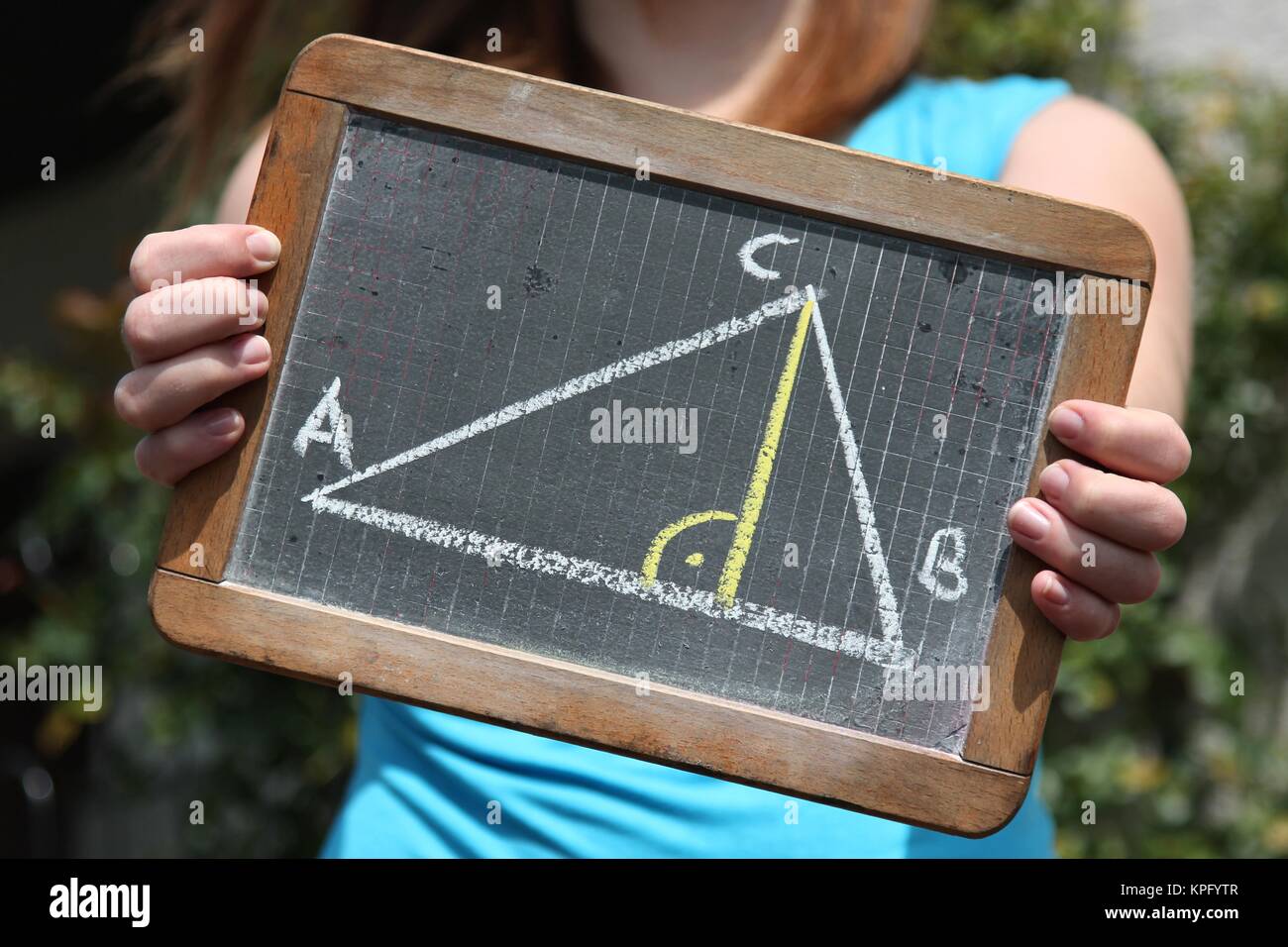 geometric triangle sketched with chalk on slate shown by young female ...