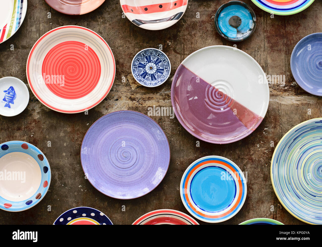 A variety of color plates and bowls on background Stock Photo - Alamy