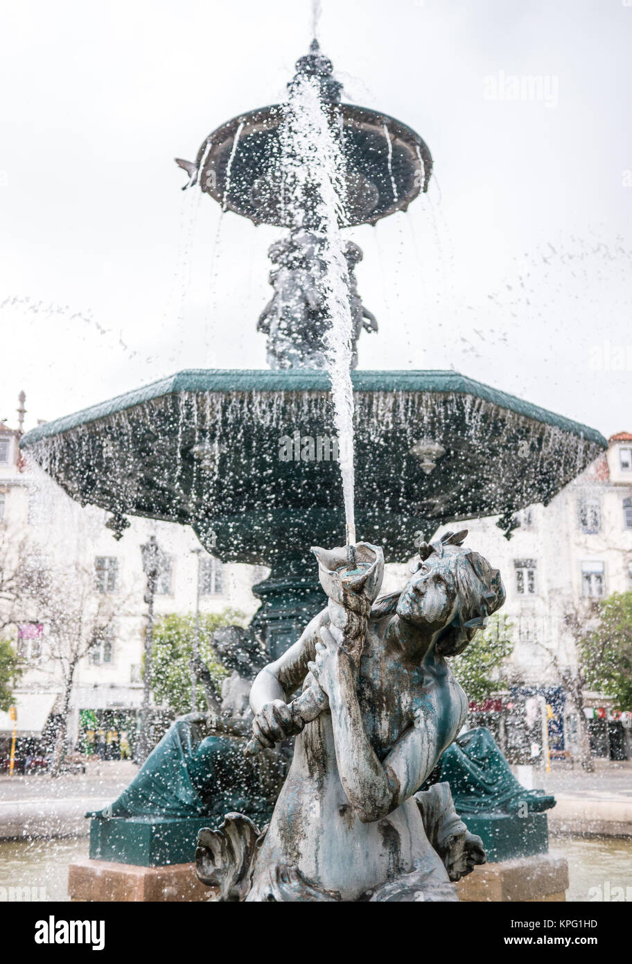 A statue of a fountain in the Rossio Square Stock Photo - Alamy
