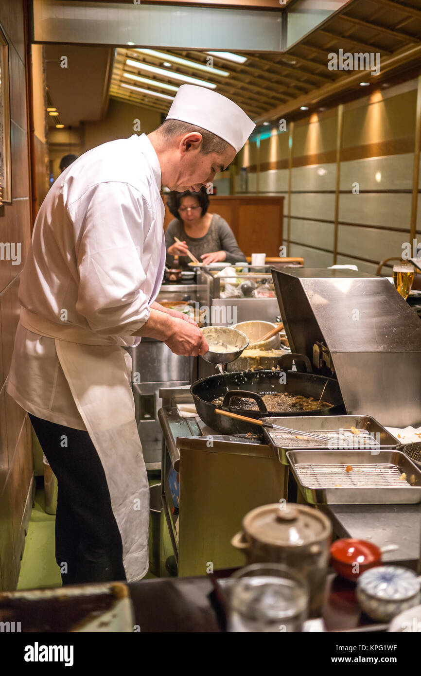 Kyoto, Japan - February 23, 2014 - A japanese chef cooking tempura in ...