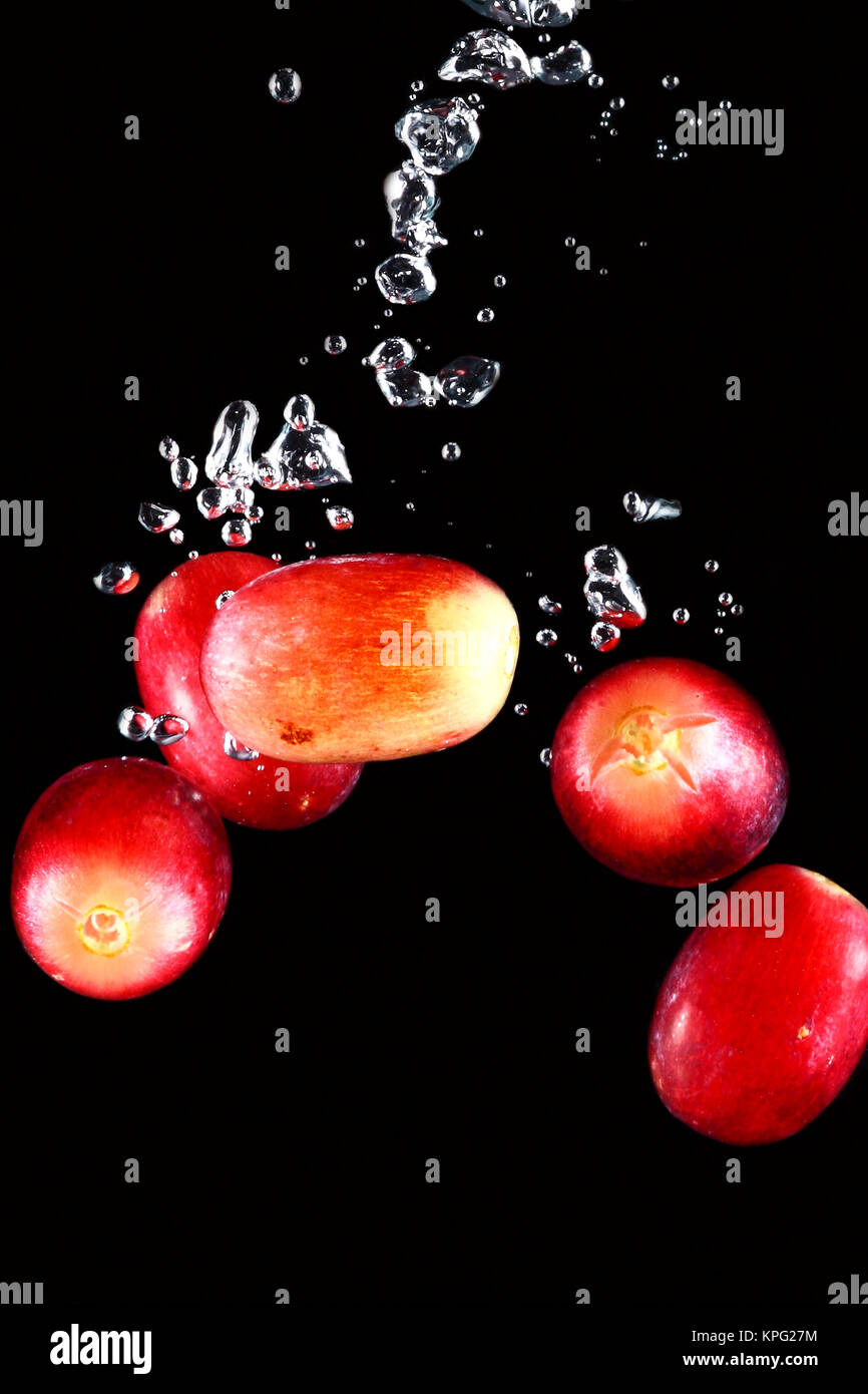 Grapes falling and splashing in to water Stock Photo - Alamy
