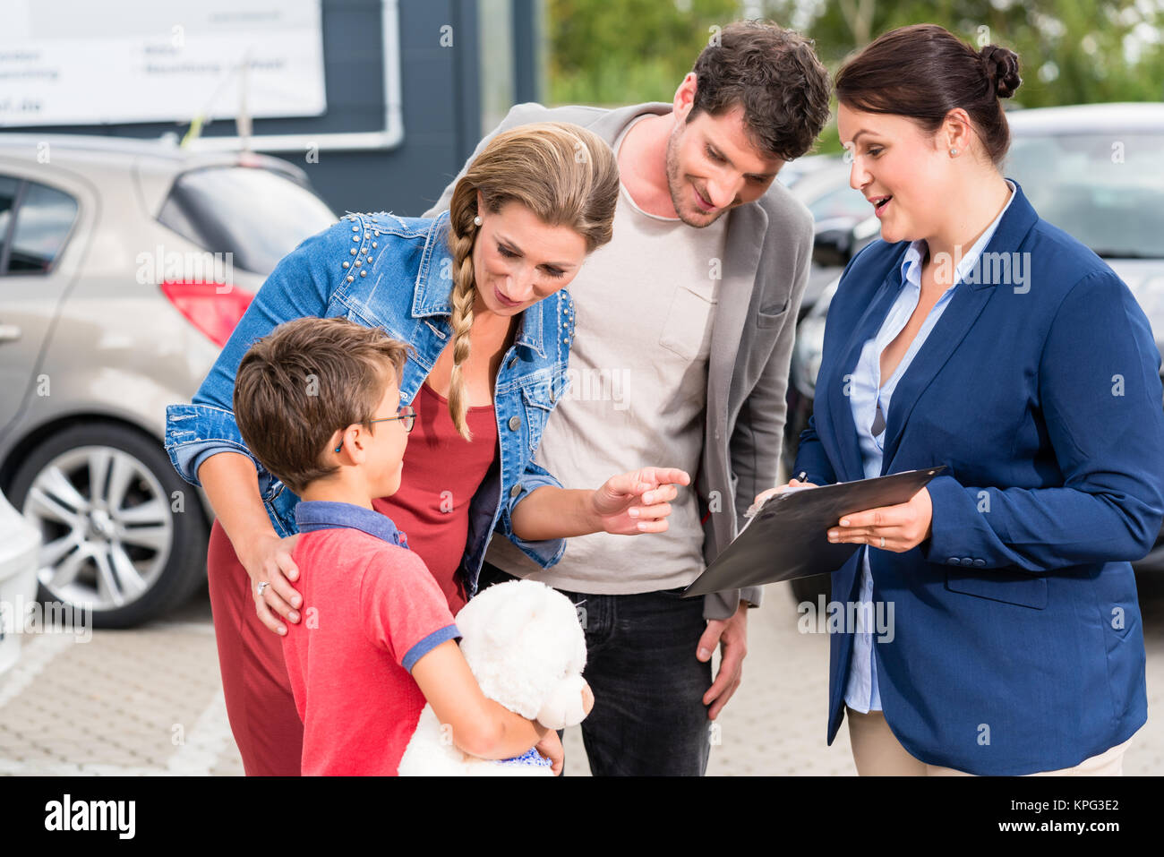 car dealer advises family in car shopping Stock Photo - Alamy