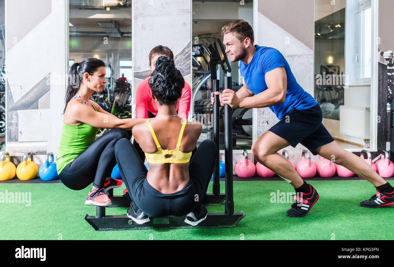 man pushes women on car as a fitness exercise Stock Photo - Alamy