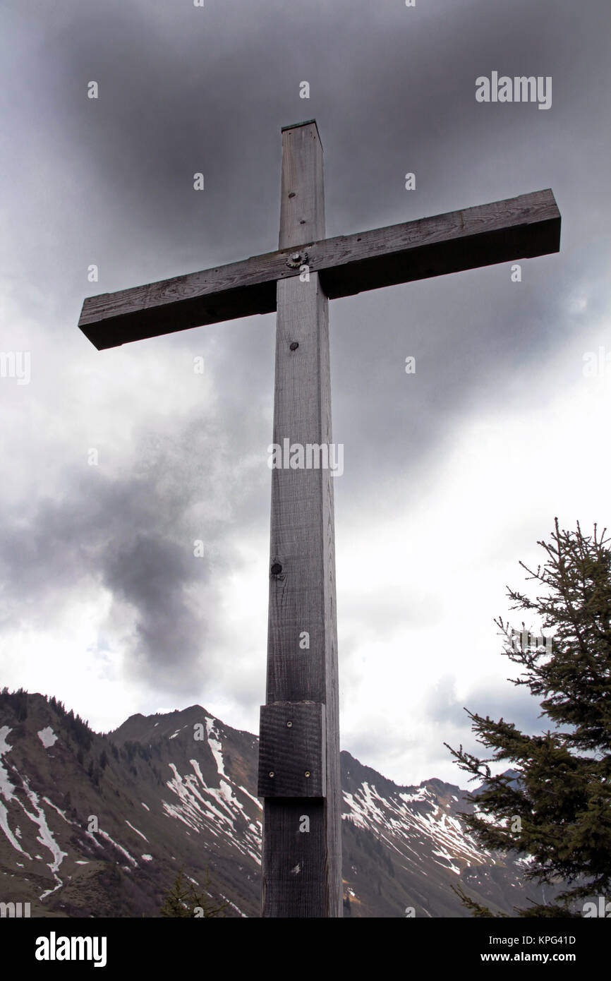 Dark rain and thunderstorm clouds in the mountains. Summit cross with ...