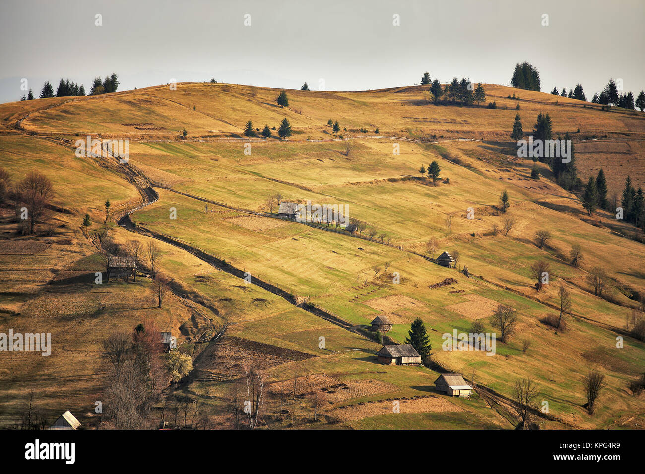 Sunny spring evening in mountain village. Fields and hills Stock Photo ...
