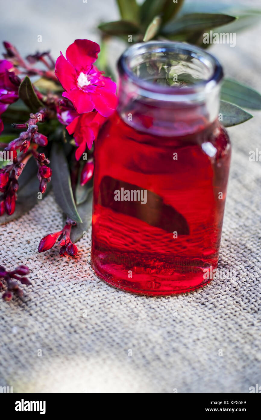 Red colored aromatic flowers with its perfume in a glass bottle Stock ...