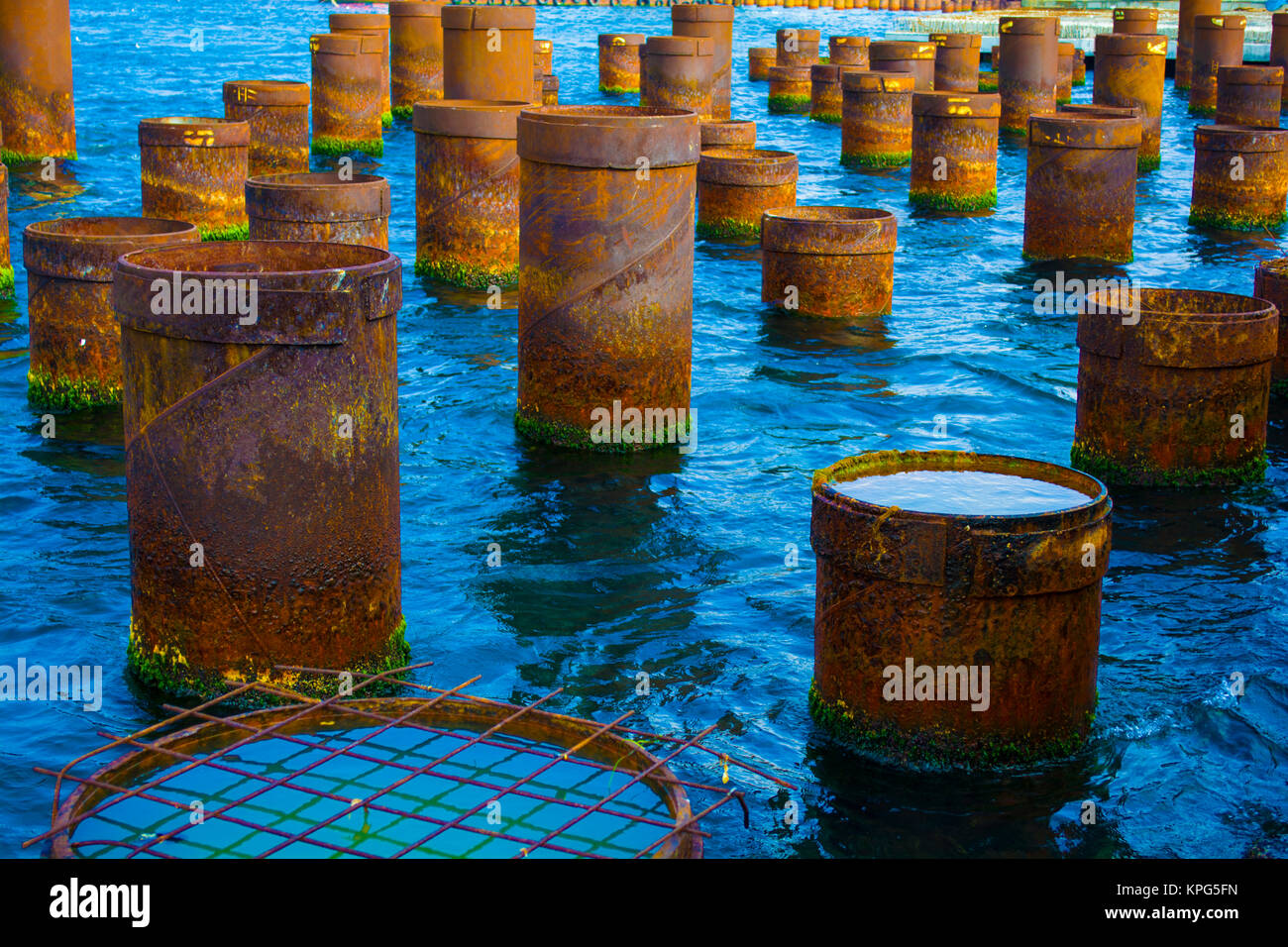 rusty steel pillars of old pier in the foreground Stock Photo - Alamy