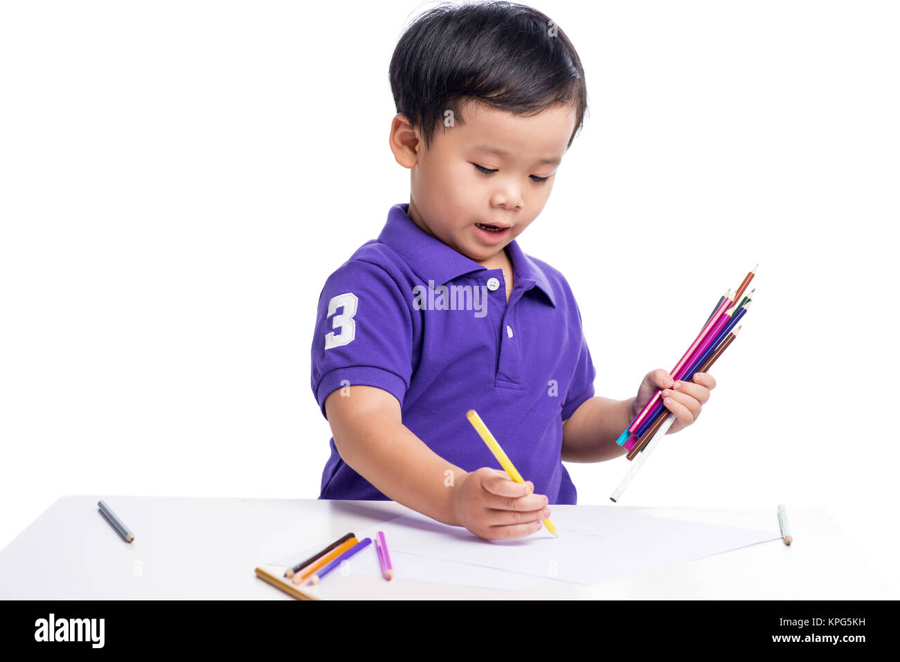 Portrait of cheerful boy drawing with colorful pencils Stock Photo - Alamy