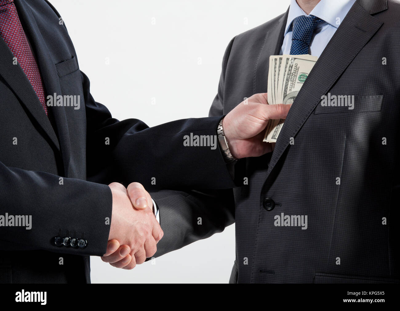 Giving a bribe into a pocket Stock Photo - Alamy