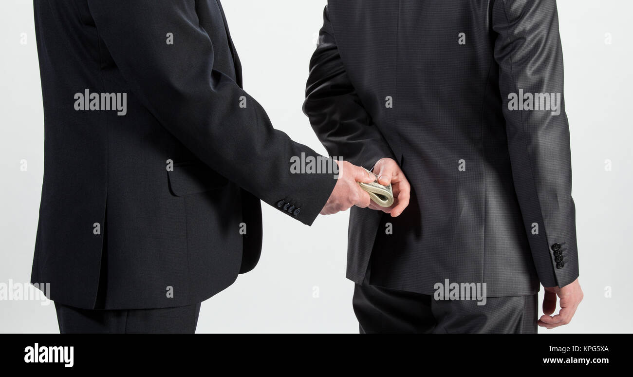 Businessman giving a bribe, neutral background Stock Photo - Alamy