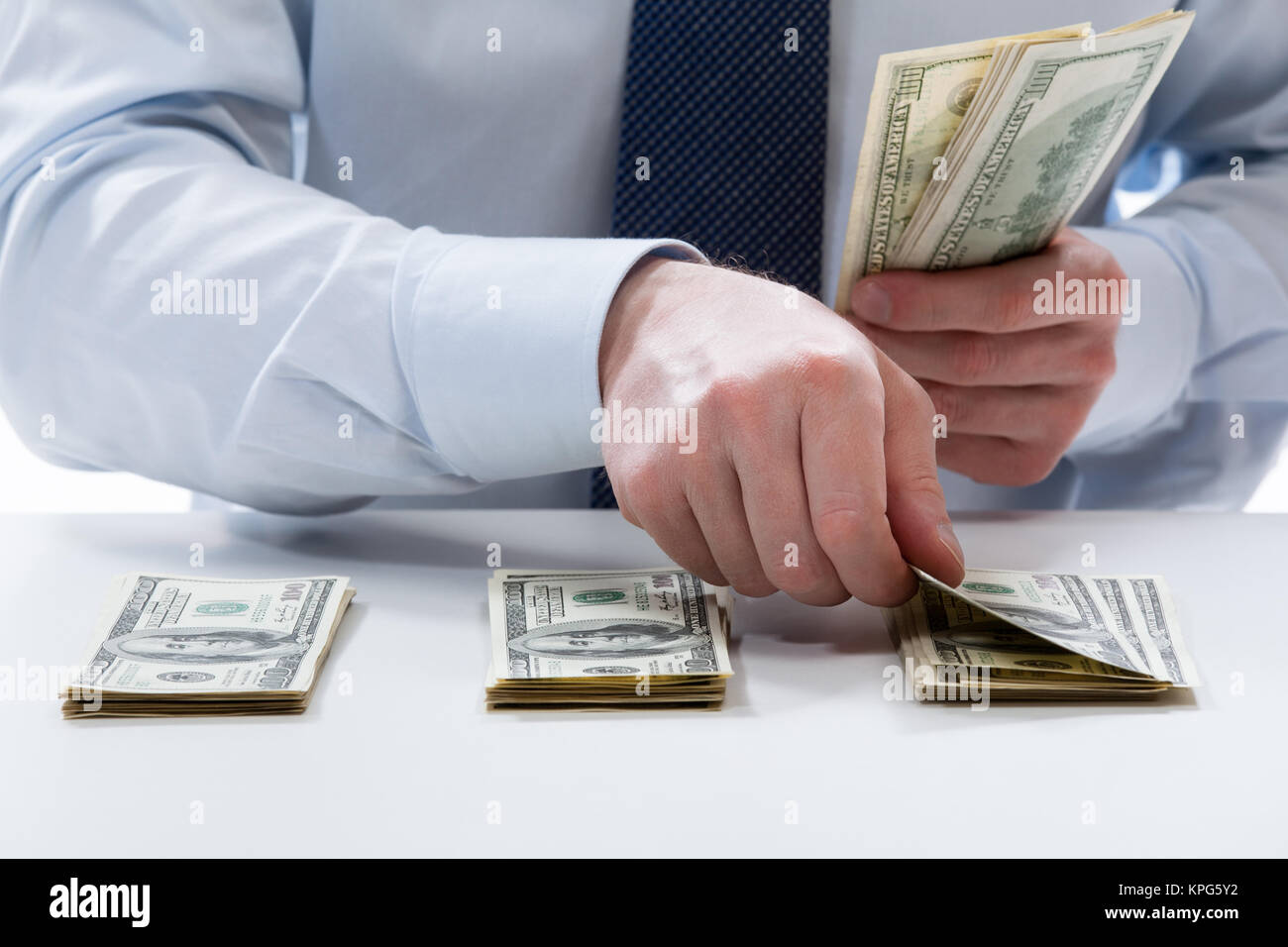 Bank teller counting dollar banknotes Stock Photo - Alamy